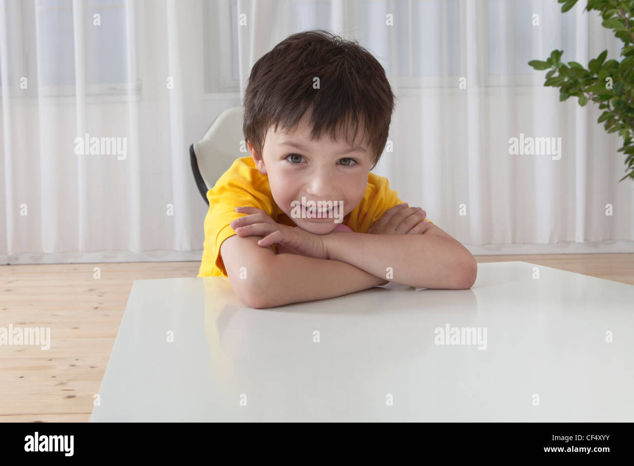 Germany, Munich, Boy with arms crossed, smiling, portrait Stock Photo ...
