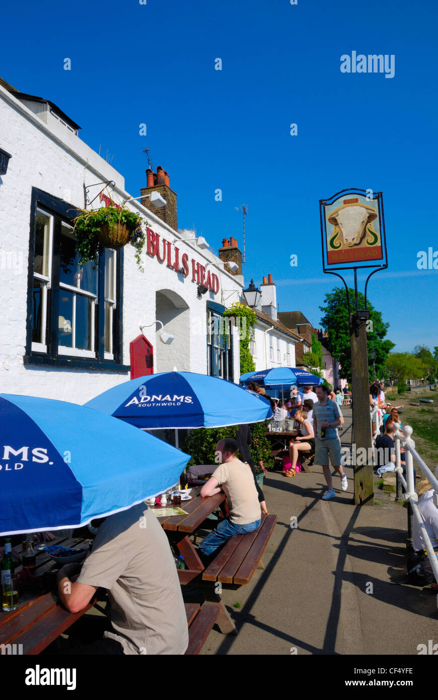 People sitting outside The Bulls Head pub at Strand-on-the-Green the ...