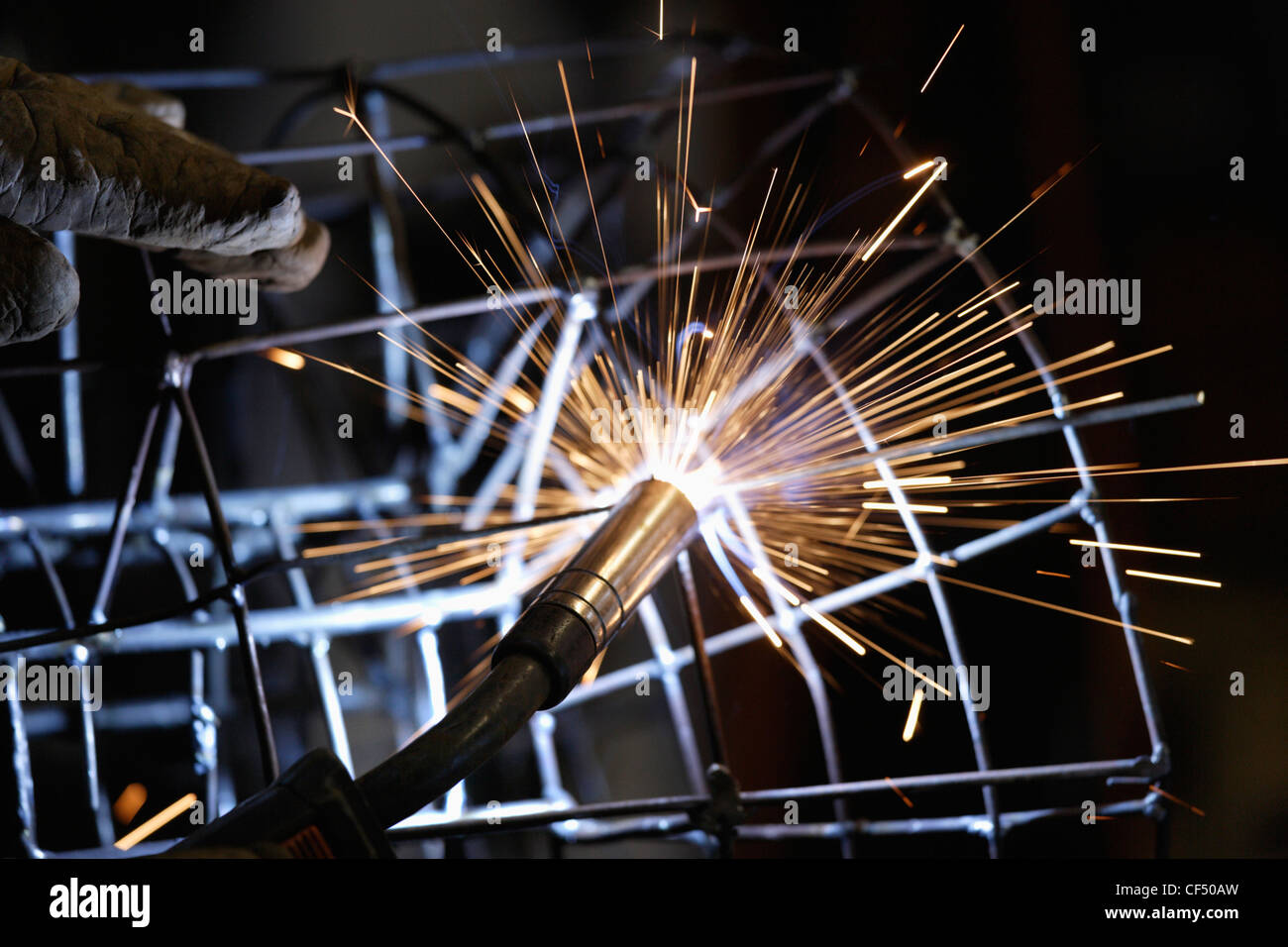 Germany, Upper Bavaria, Munich, Schaeftlarn, Sculptor welding at work ...