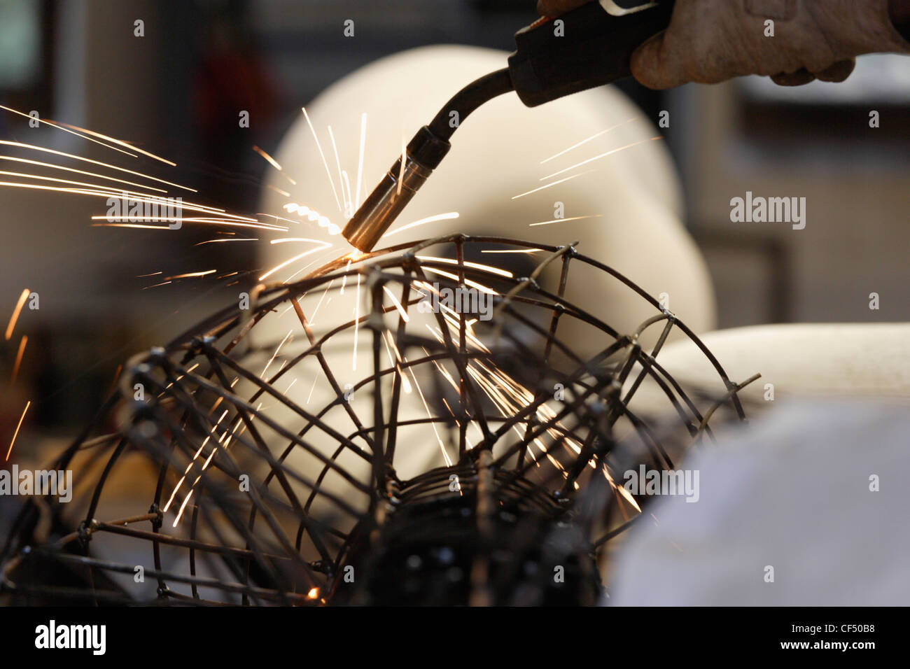 Germany, Upper Bavaria, Munich, Schaeftlarn, Sculptor welding at work ...