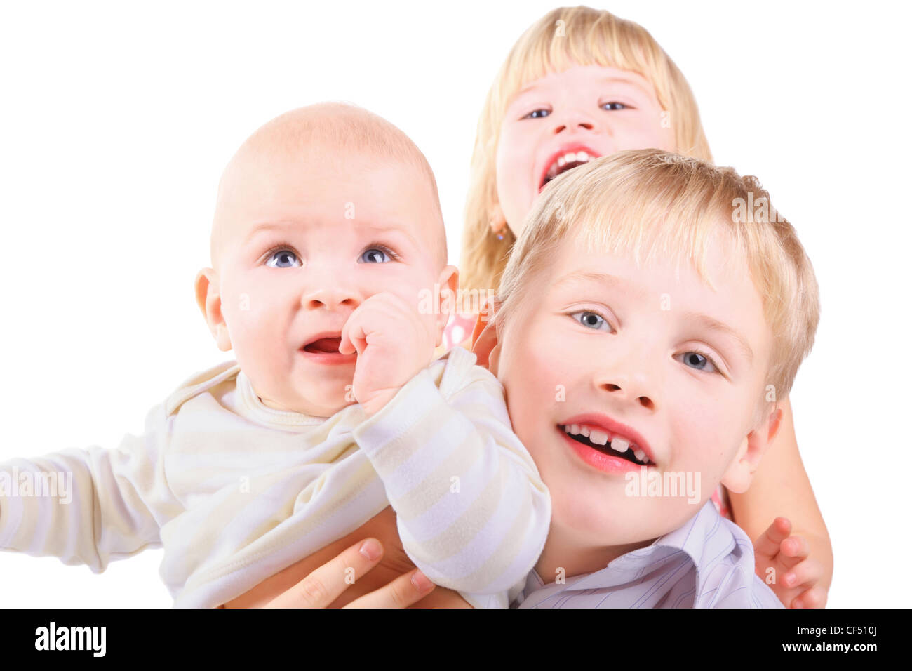 little boy is holding baby. little girl is standing behind little boy ...