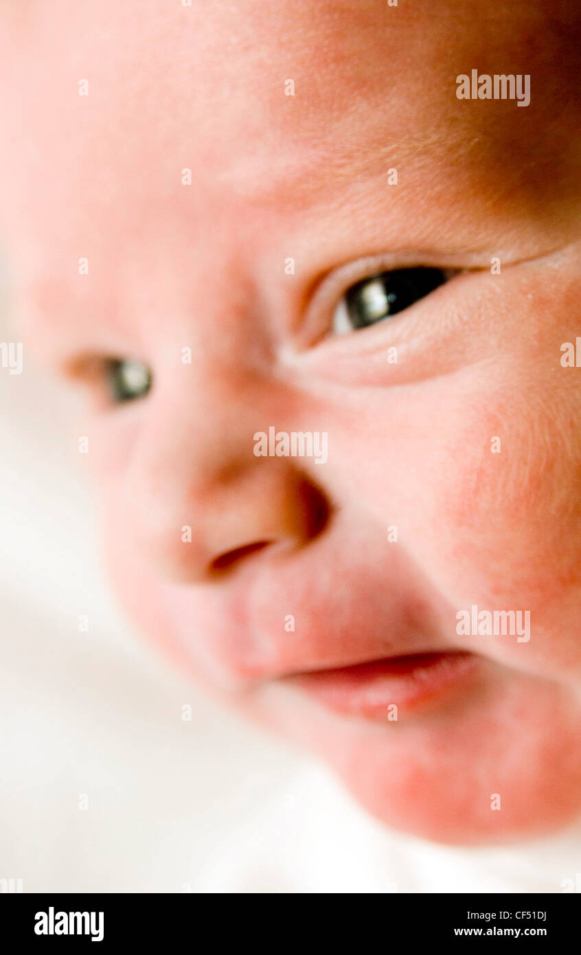 Close up of new born baby in half profile, looking sad Stock Photo - Alamy