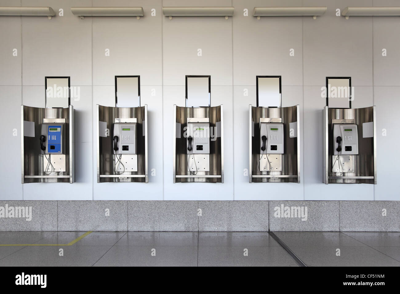 many public phones in big hall with white walls and granite floor Stock ...