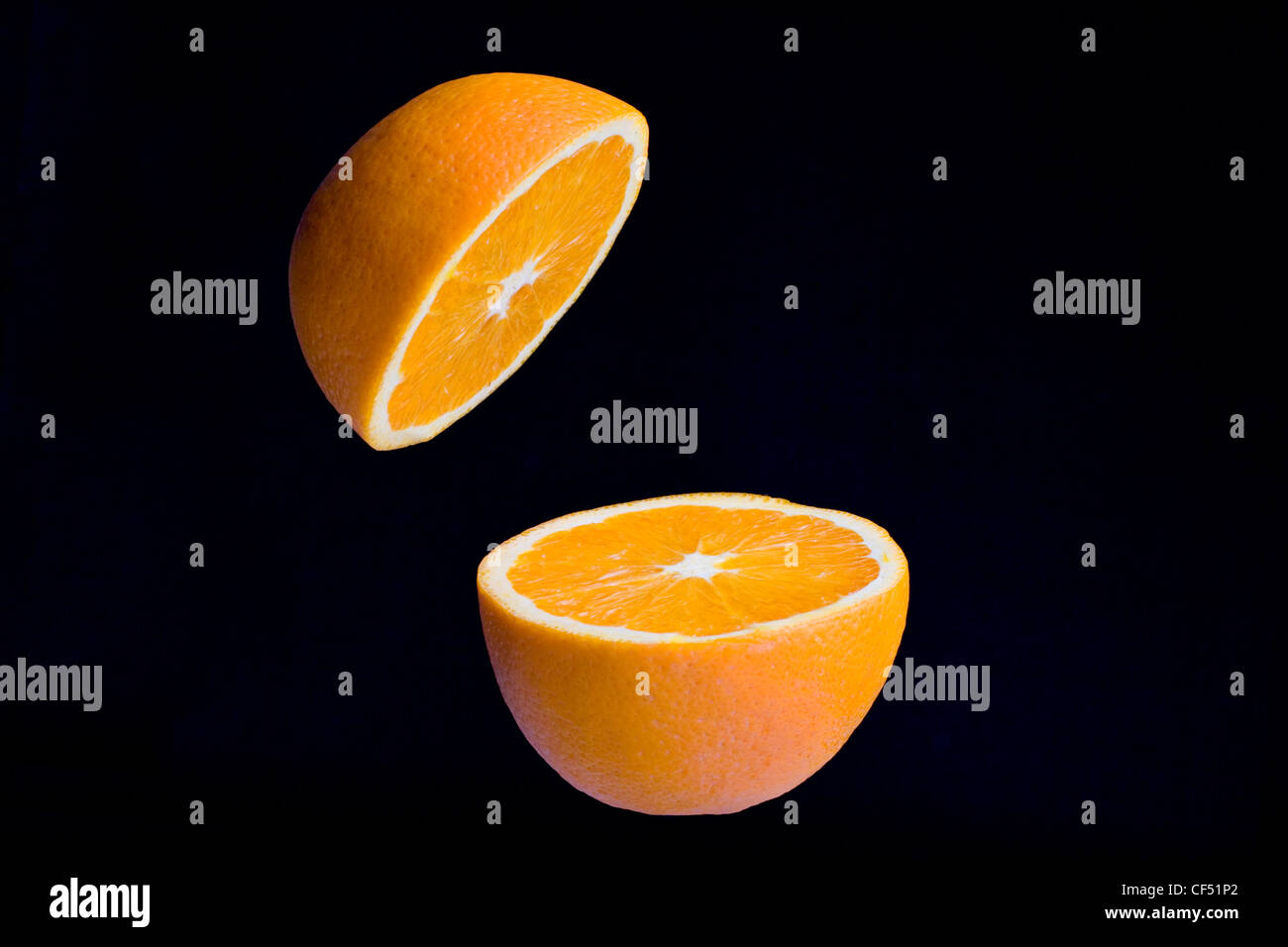 Fresh orange cut into two pieces Stock Photo - Alamy