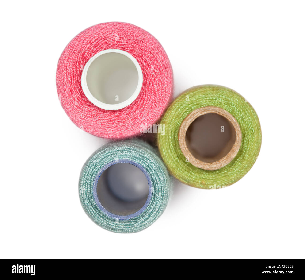 Three coils with multi-coloured sewing threads isolated on white ...