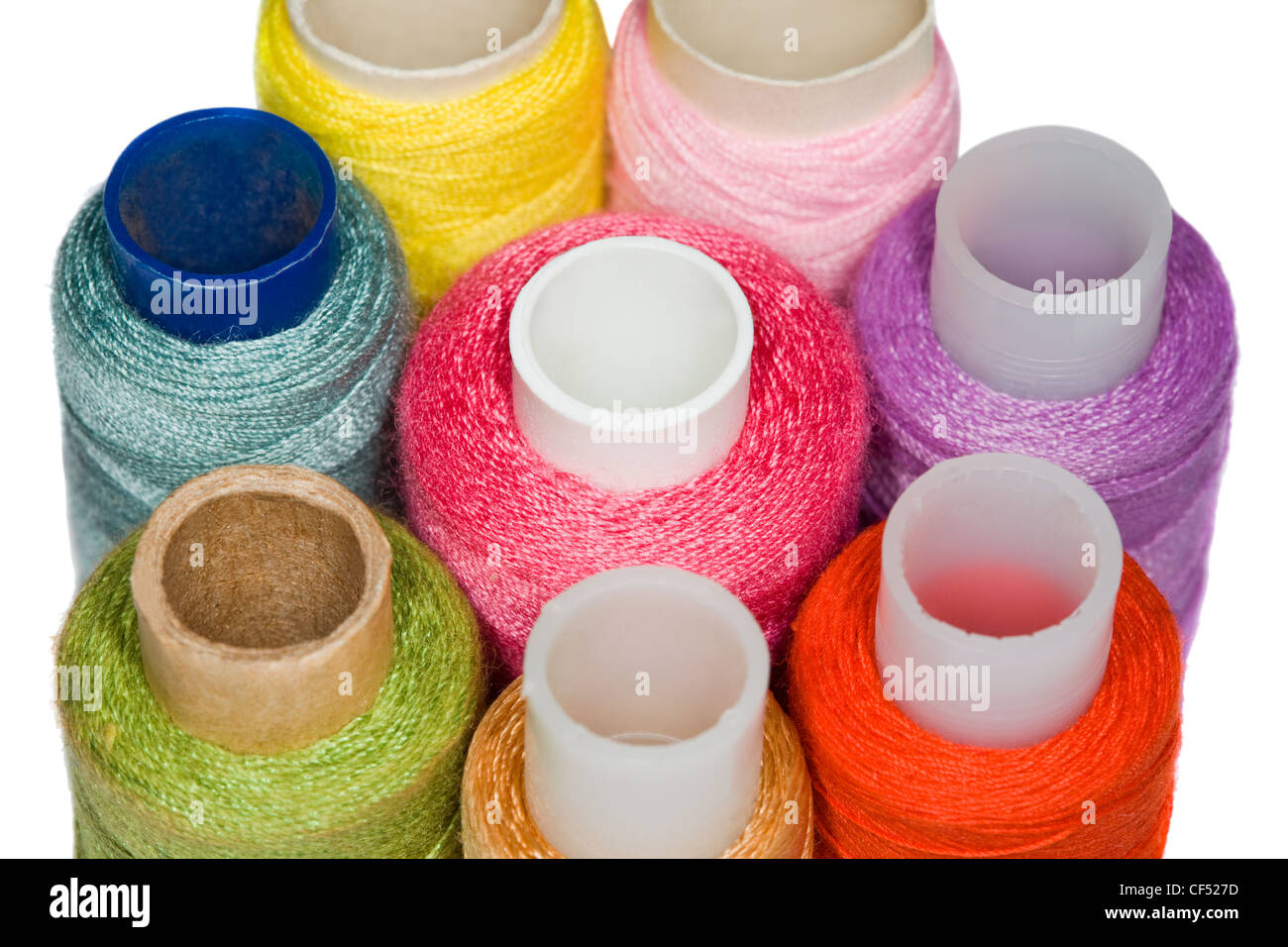 spools with multi-coloured sewing threads isolated on white background ...