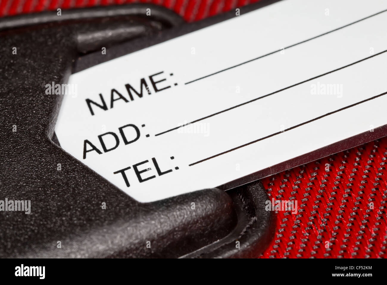 Fragment of label with identification data on red textural fabric Stock ...