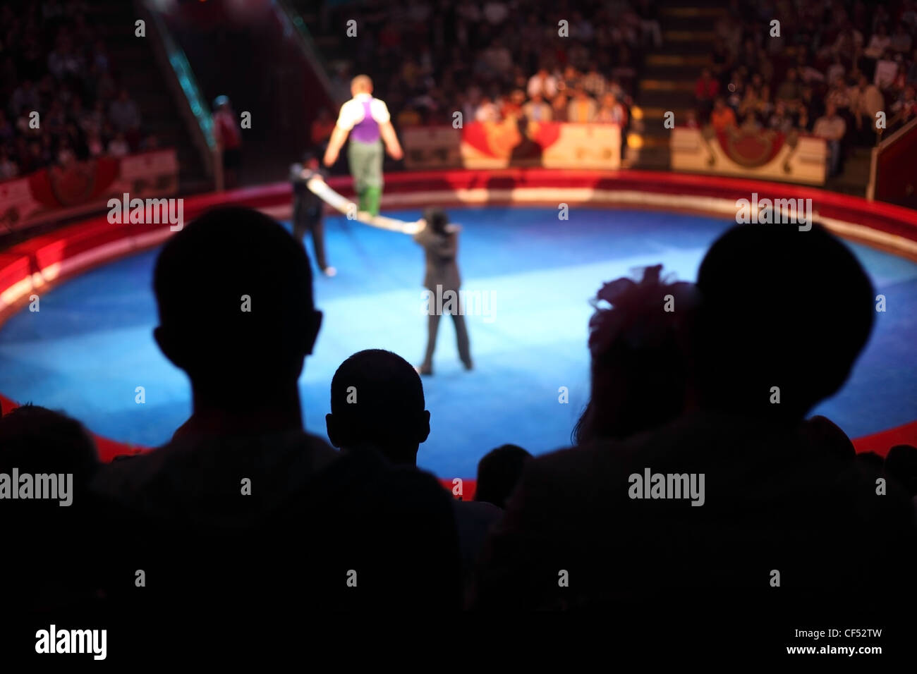 blue arena in circus performance with acrobat on bean focus on ...