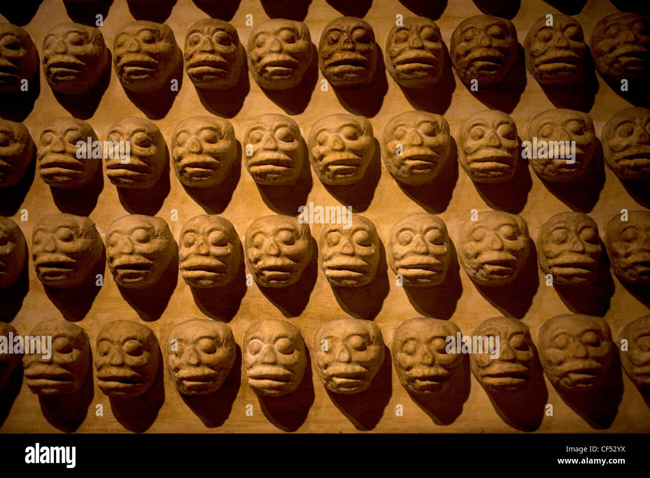 A Totonacan wall decorated with sculptures of human skulls is displayed ...