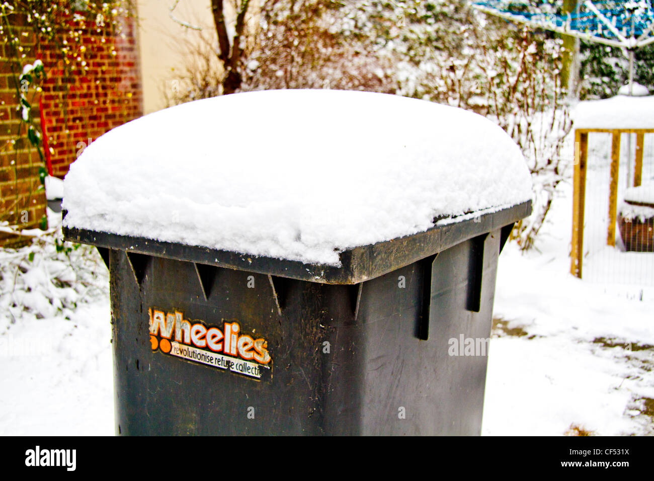 Snow covered wheeled refuse or garbage container Stock Photo - Alamy