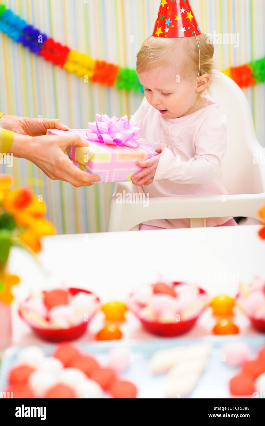 Surprised baby receiving present on first birthday Stock Photo - Alamy