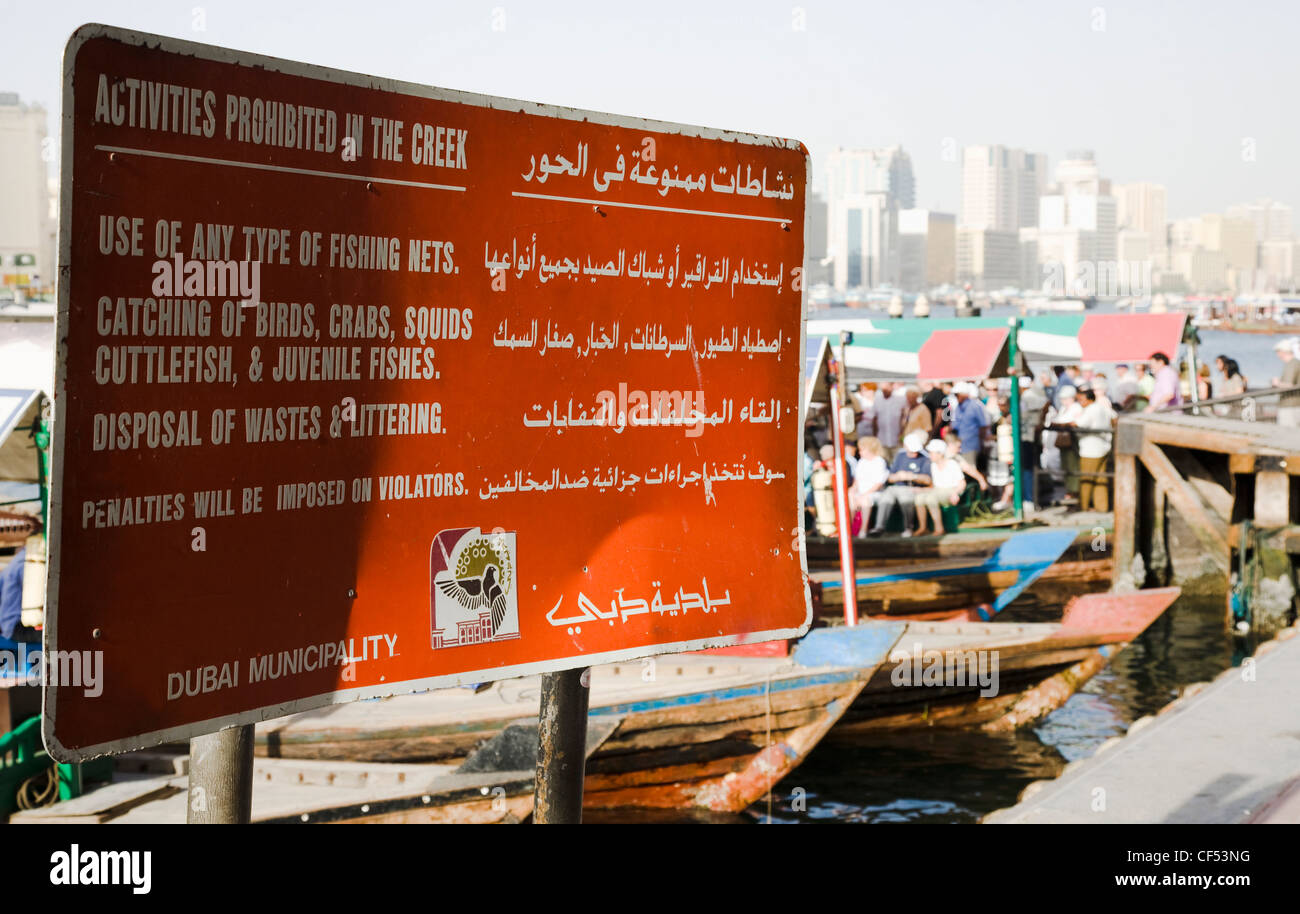 Municipal sign showing rules and penalties on the Creek with skyline ...
