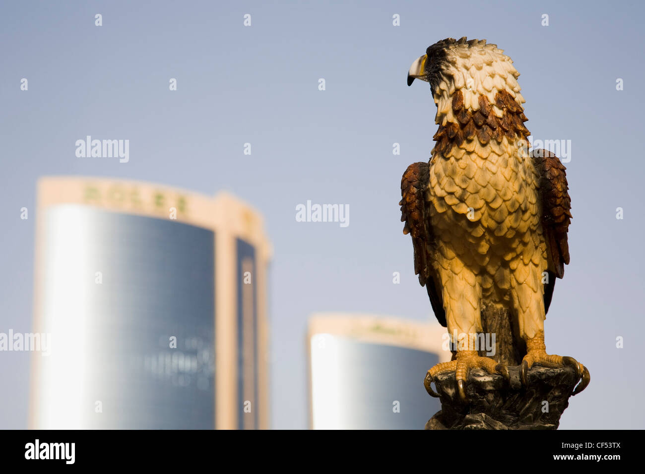 UAE, Gulf State, Dubai, Falcon statue on the Creek with Twin Towers ...