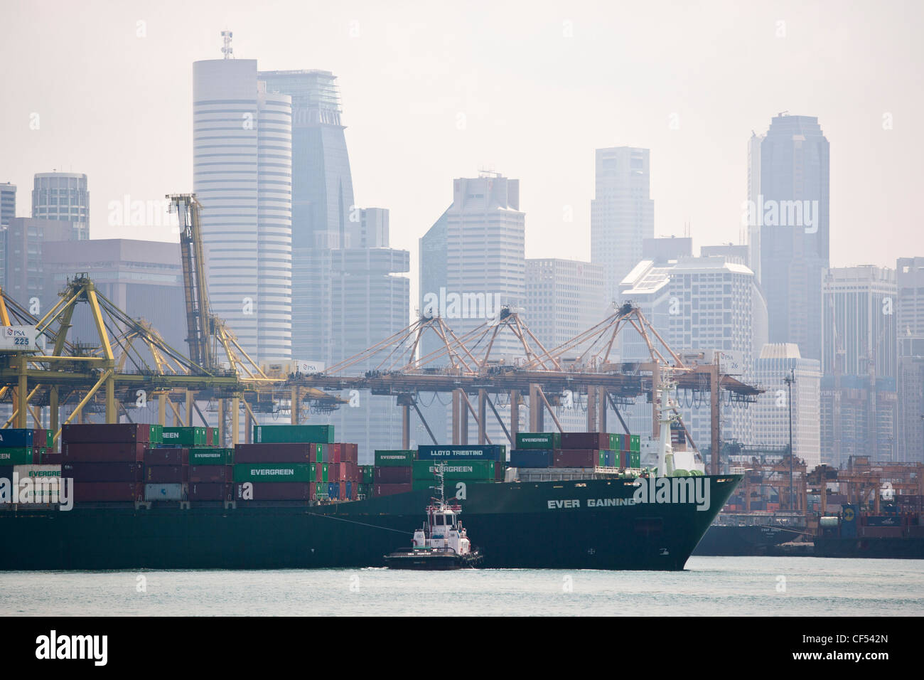 A container ship is maneuvered into position at the Brani terminal of ...