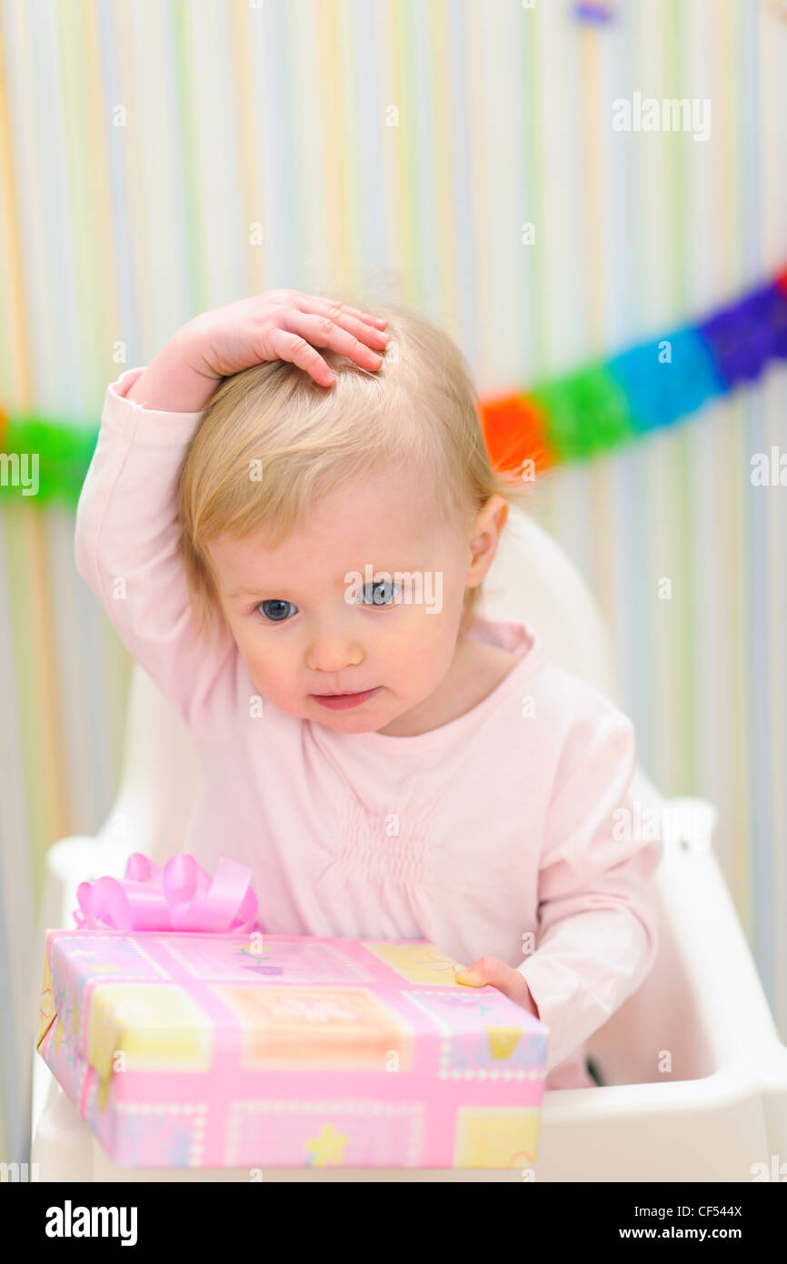 Portrait of embarrassed baby celebrating first birthday Stock Photo - Alamy