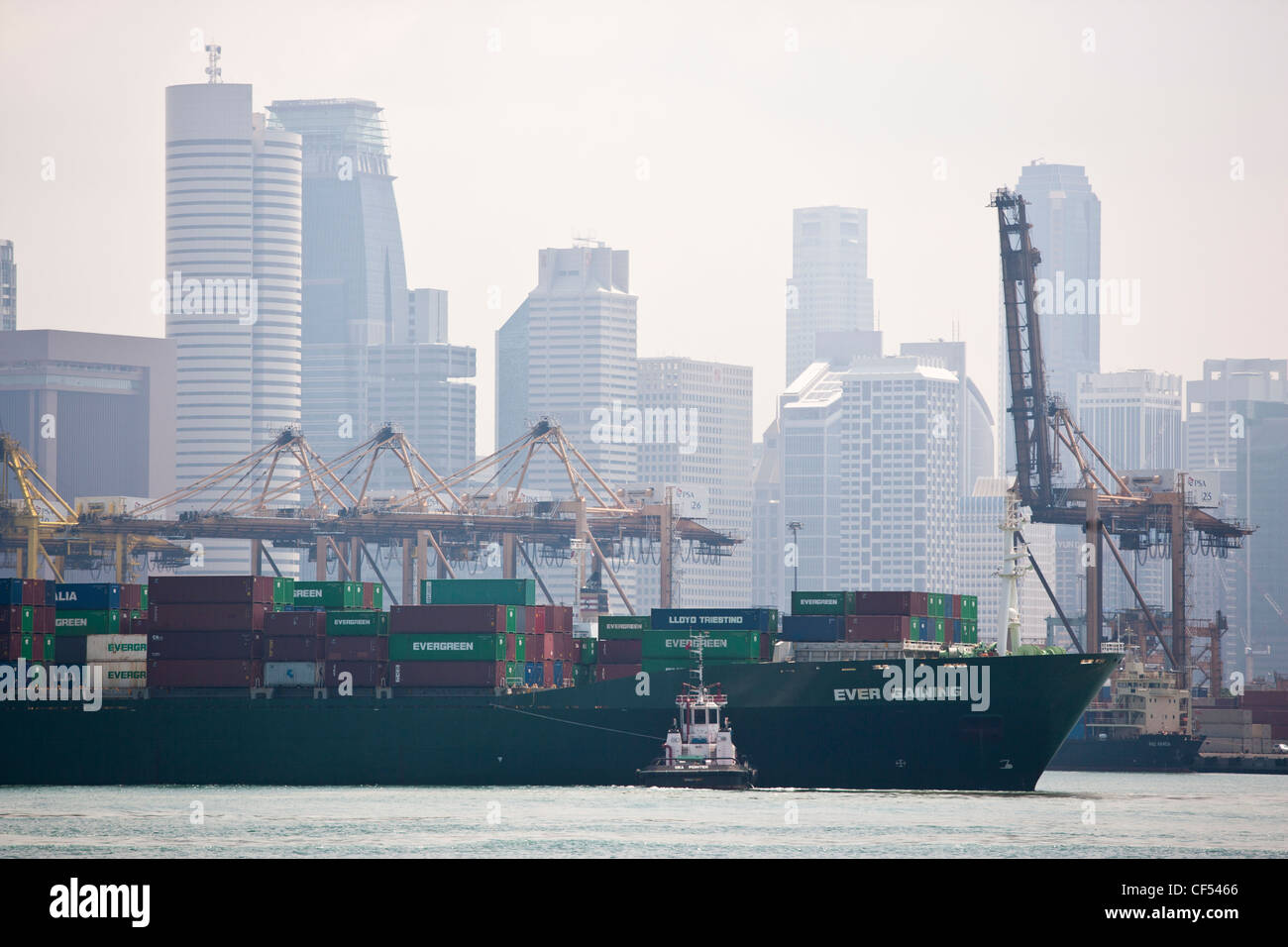 A container ship is maneuvered into position at the Brani terminal of ...