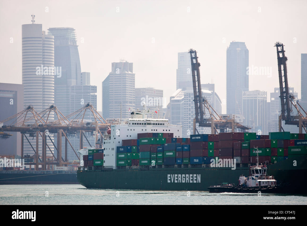 A container ship is maneuvered into position at the Brani terminal of ...
