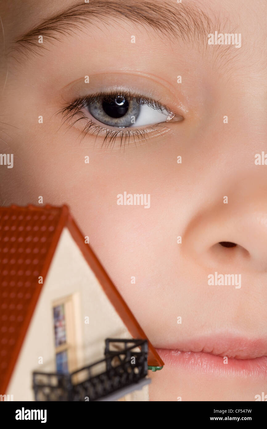 face of little girl near toy plastic house with balcony Stock Photo - Alamy