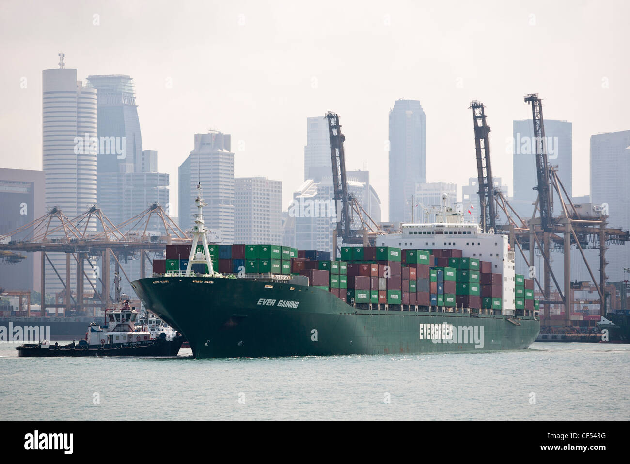 A container ship is maneuvered into position at the Brani terminal of ...
