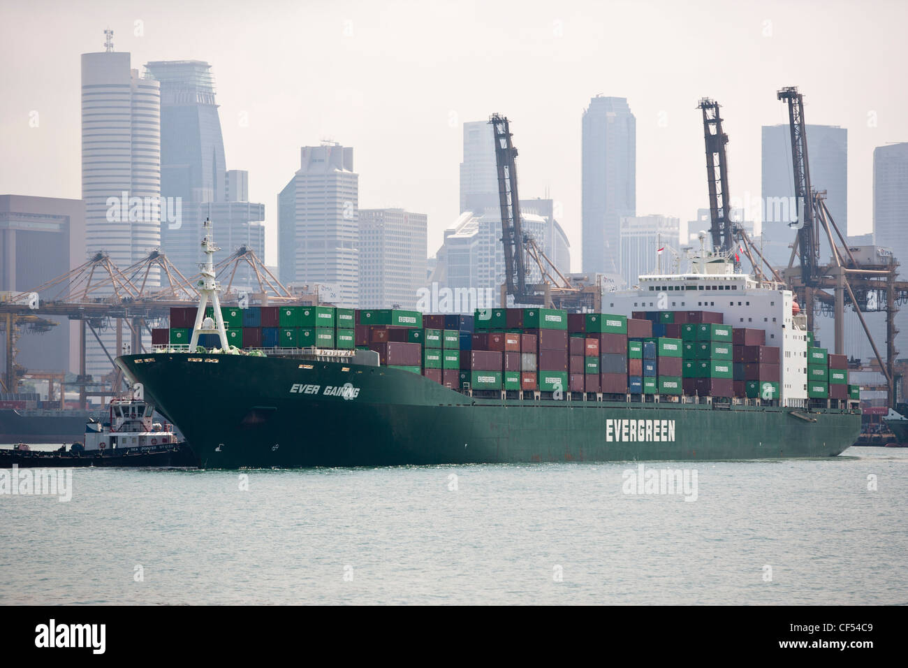 A container ship is maneuvered into position at the Brani terminal of ...