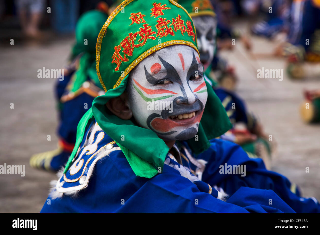 Thai boy in Chinese character costume in dance troupe celebrating local ...