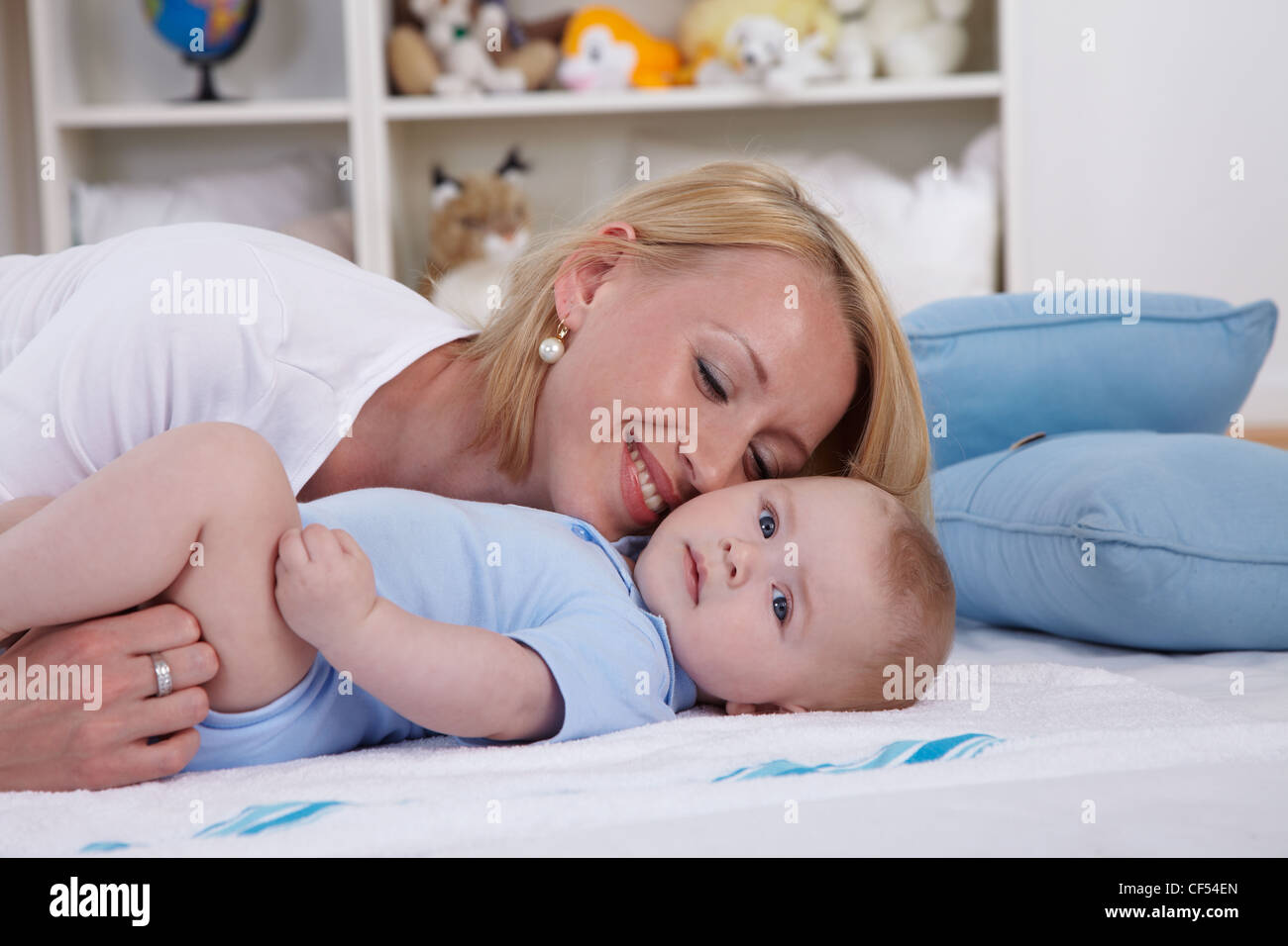 mother play on floor with her baby Stock Photo - Alamy
