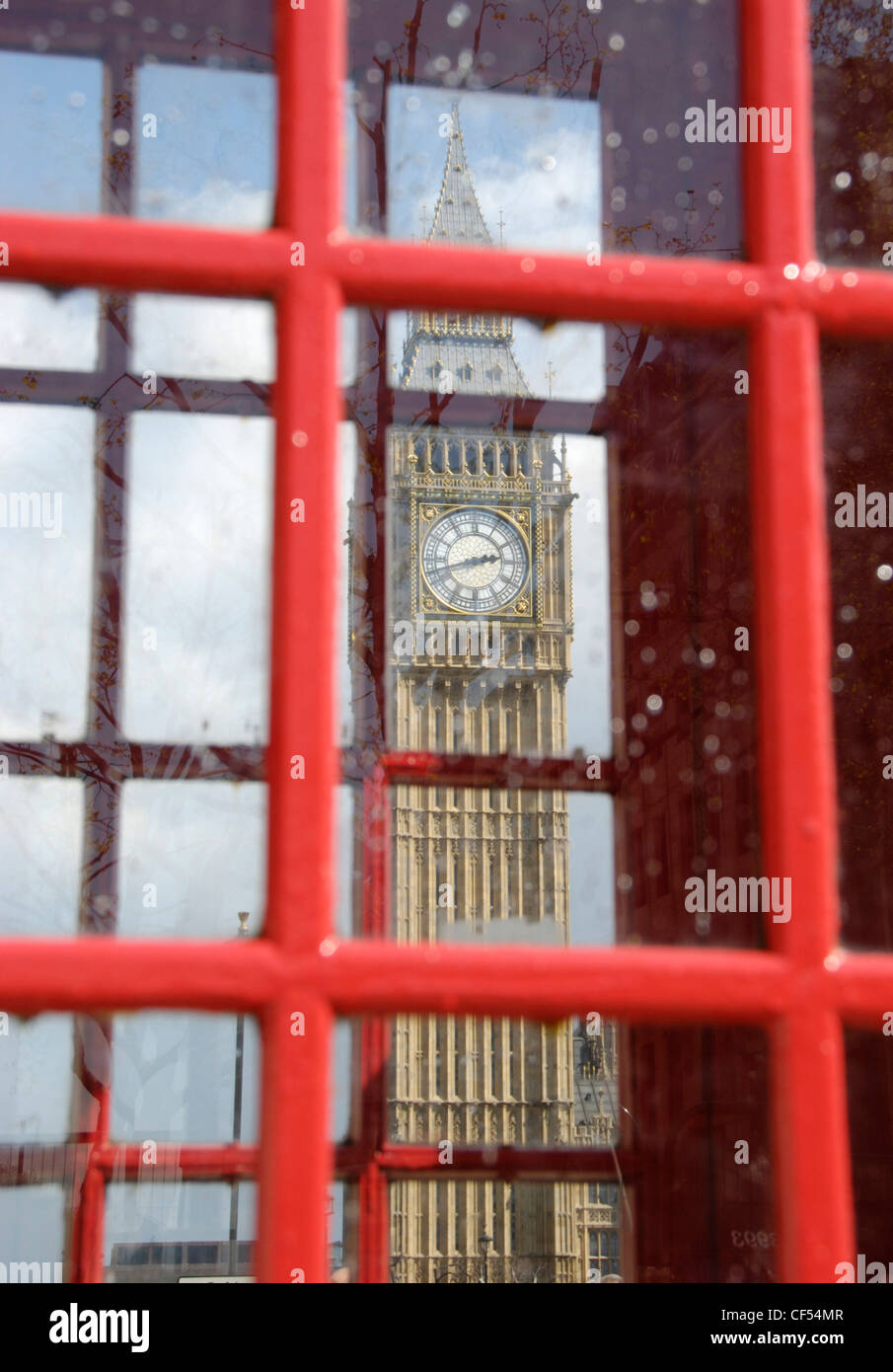 Big Ben viewed through the wet window of traditional British red public ...