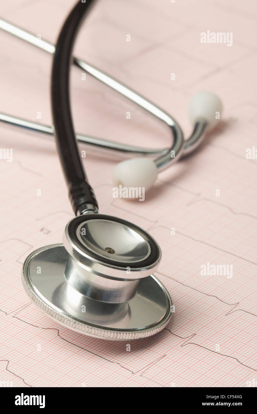 Stethoscope on ecg report, close up Stock Photo - Alamy