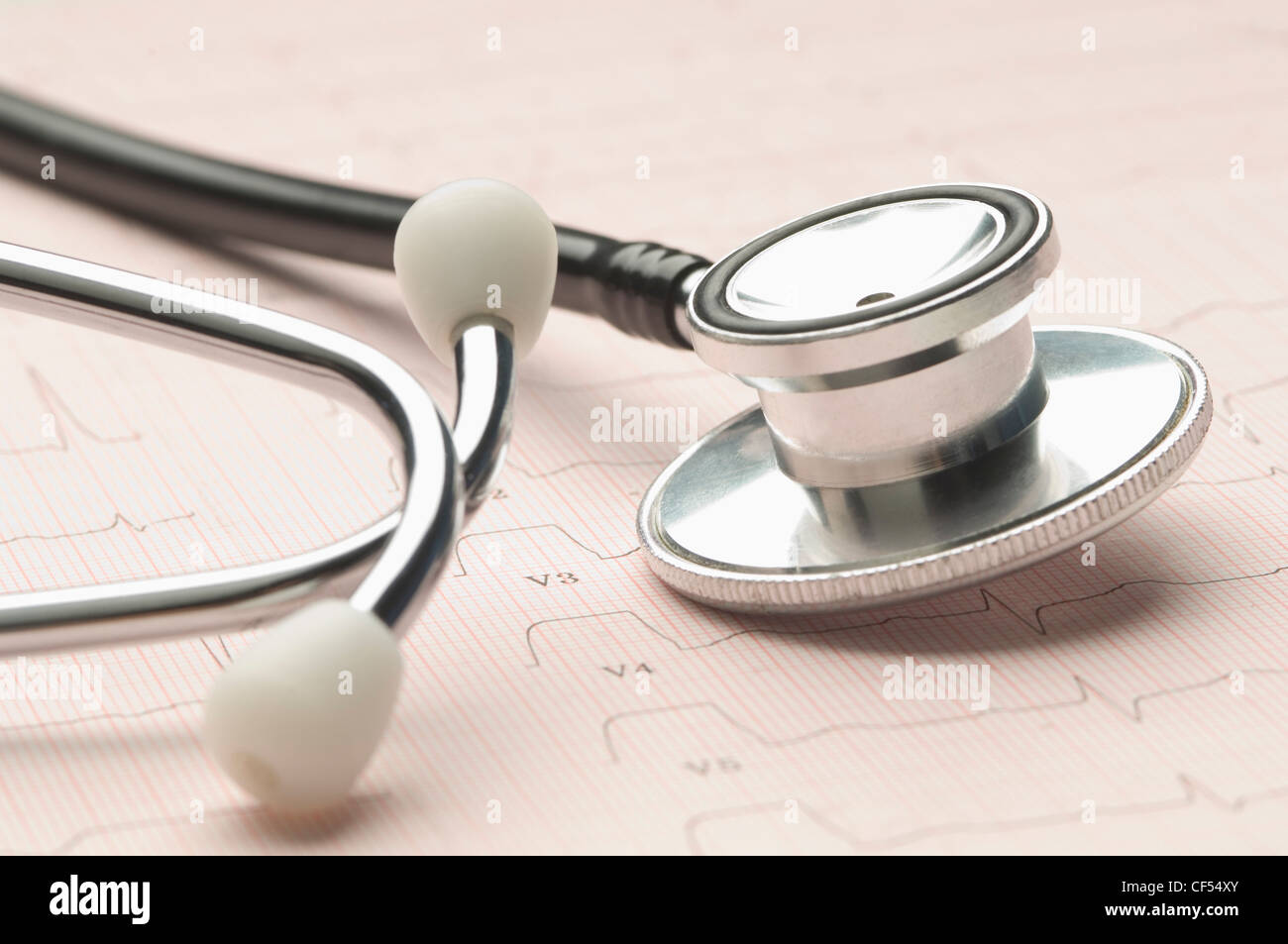Stethoscope on ecg report, close up Stock Photo - Alamy