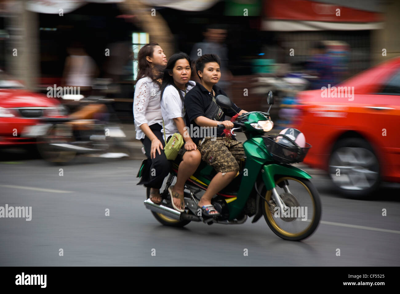 Young Thai women on motorcycle without helmets helmet in shopping ...