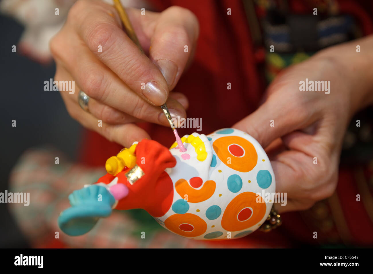 Painting pottery figurines. Russian folk craft. Close-up photos Stock ...