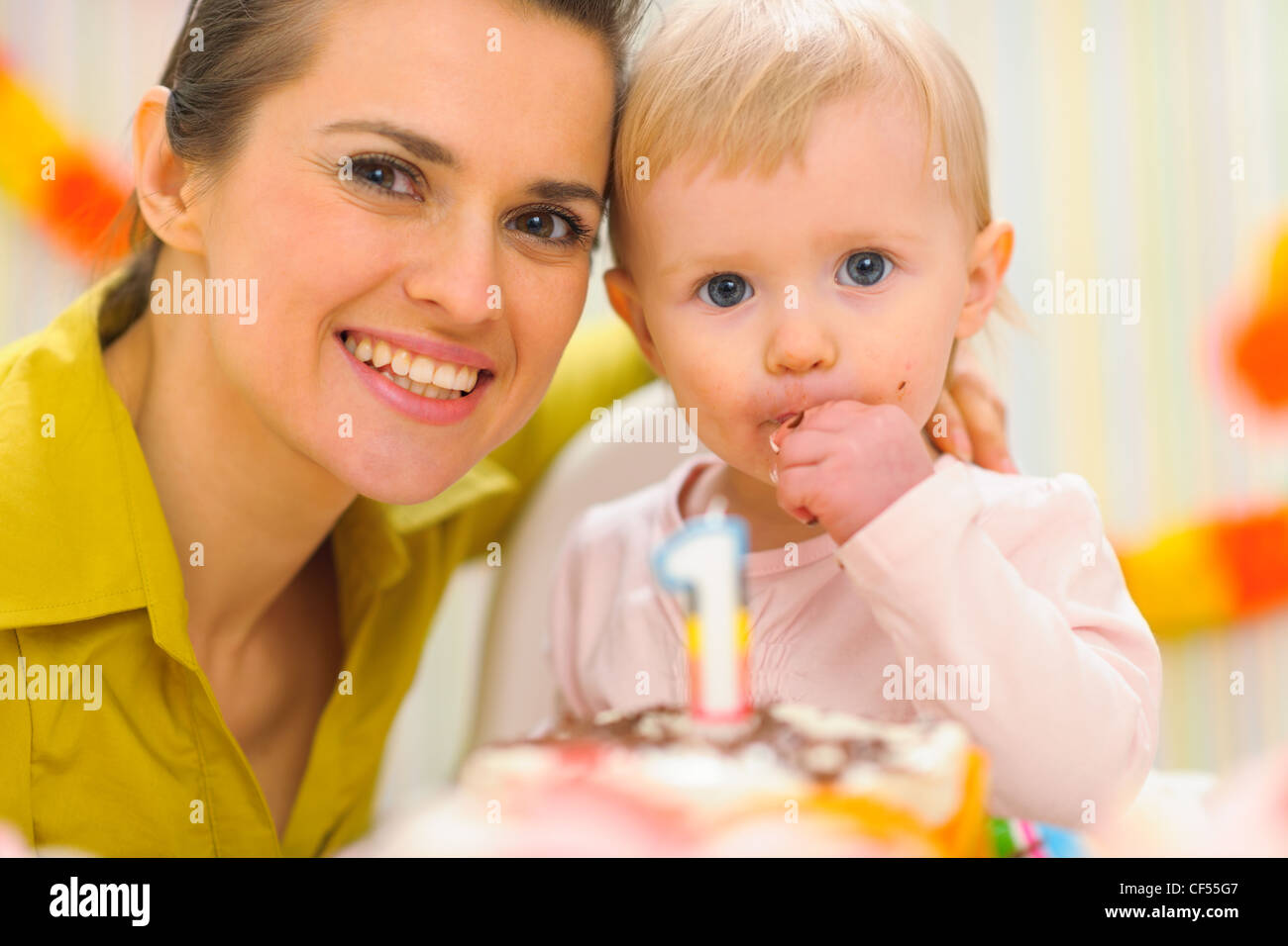Portrait of mother and kid eating birthday cake Stock Photo - Alamy