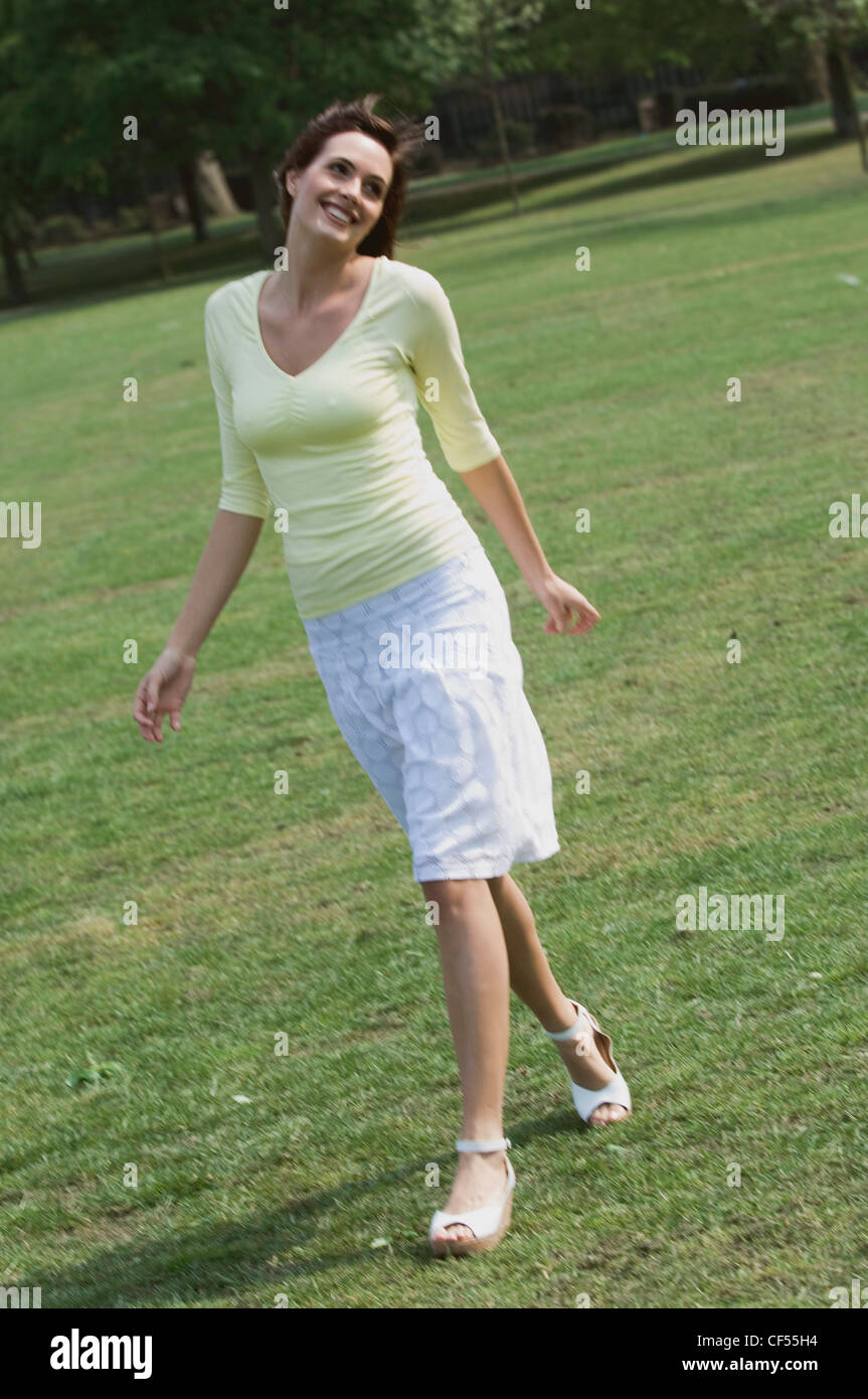 Female with straight shoulder length brunette hair, wearing pale yellow ...