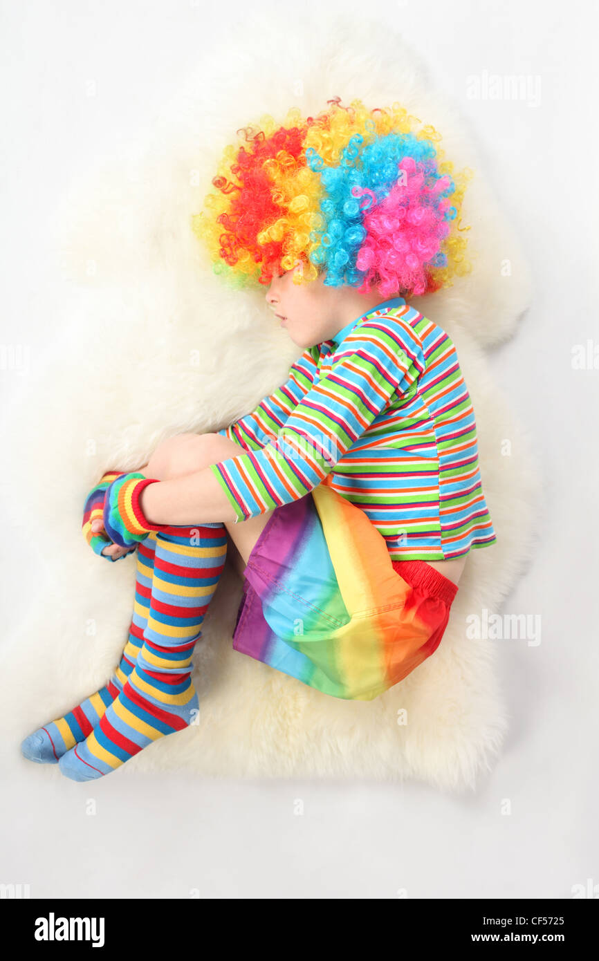 boy in clown dress sleeping view frome above on white background Stock ...