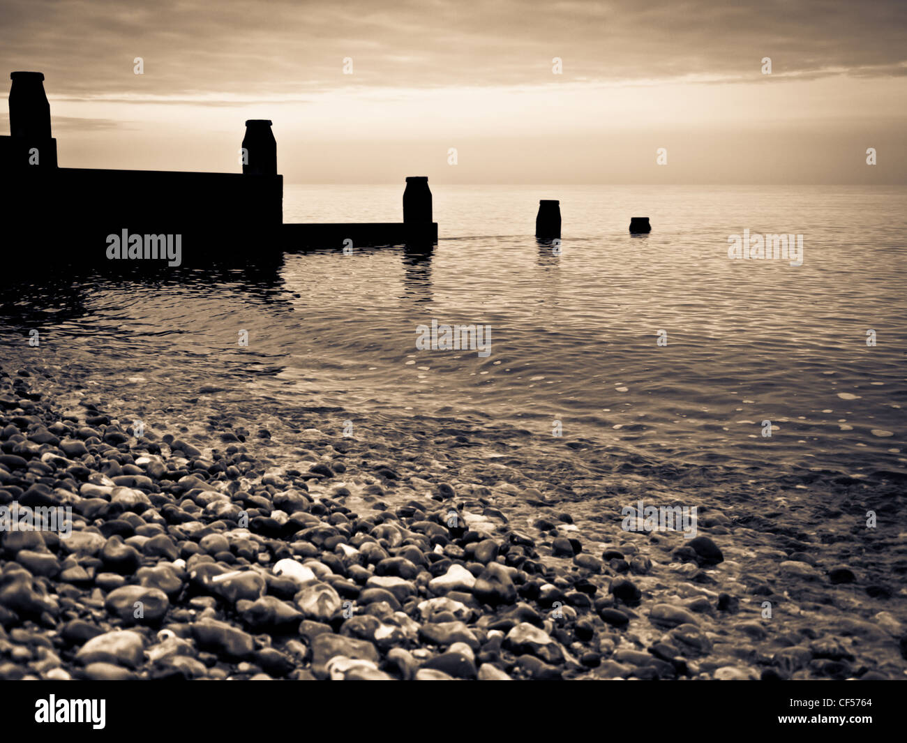 Groynes at dusk in Whitstable, Kent Stock Photo - Alamy