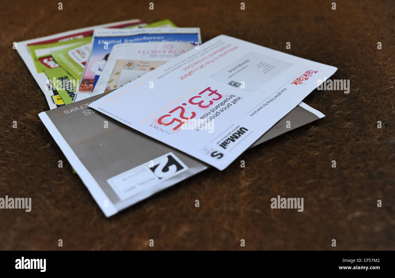 Junk mail in a private home on door mat after being delivered by ...