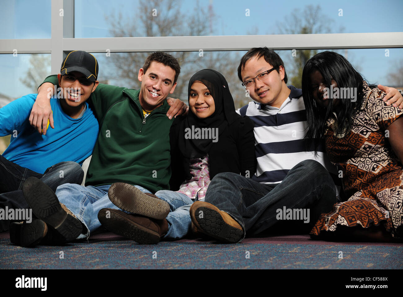 Diverse Group of Students smiling by a window Stock Photo - Alamy