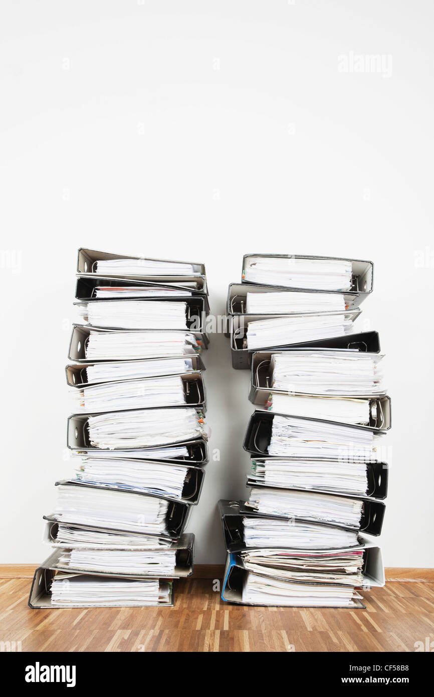 Piled of office files on parquet floor Stock Photo - Alamy