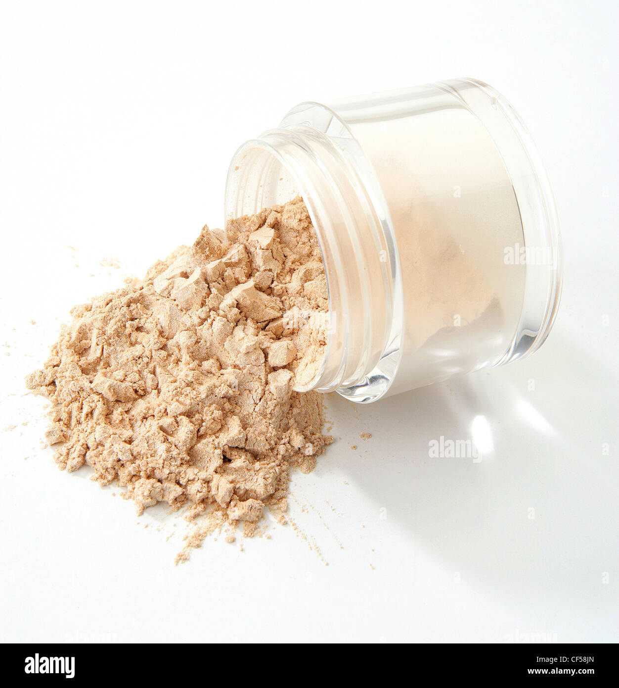 Clear pot on side spilling powder Stock Photo - Alamy