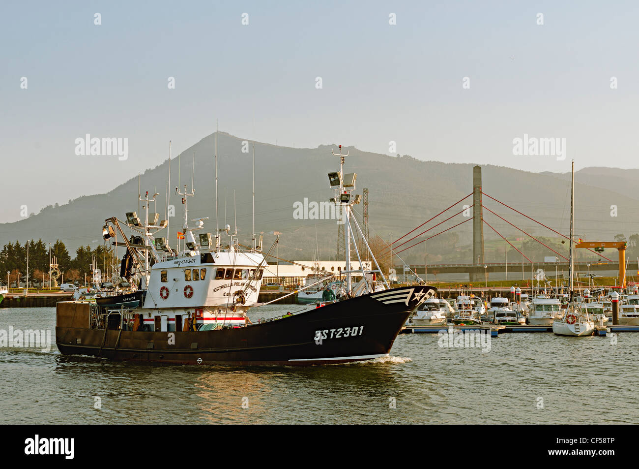 fishing boat leaving the darsena of the port of Colindres, Cantabria ...