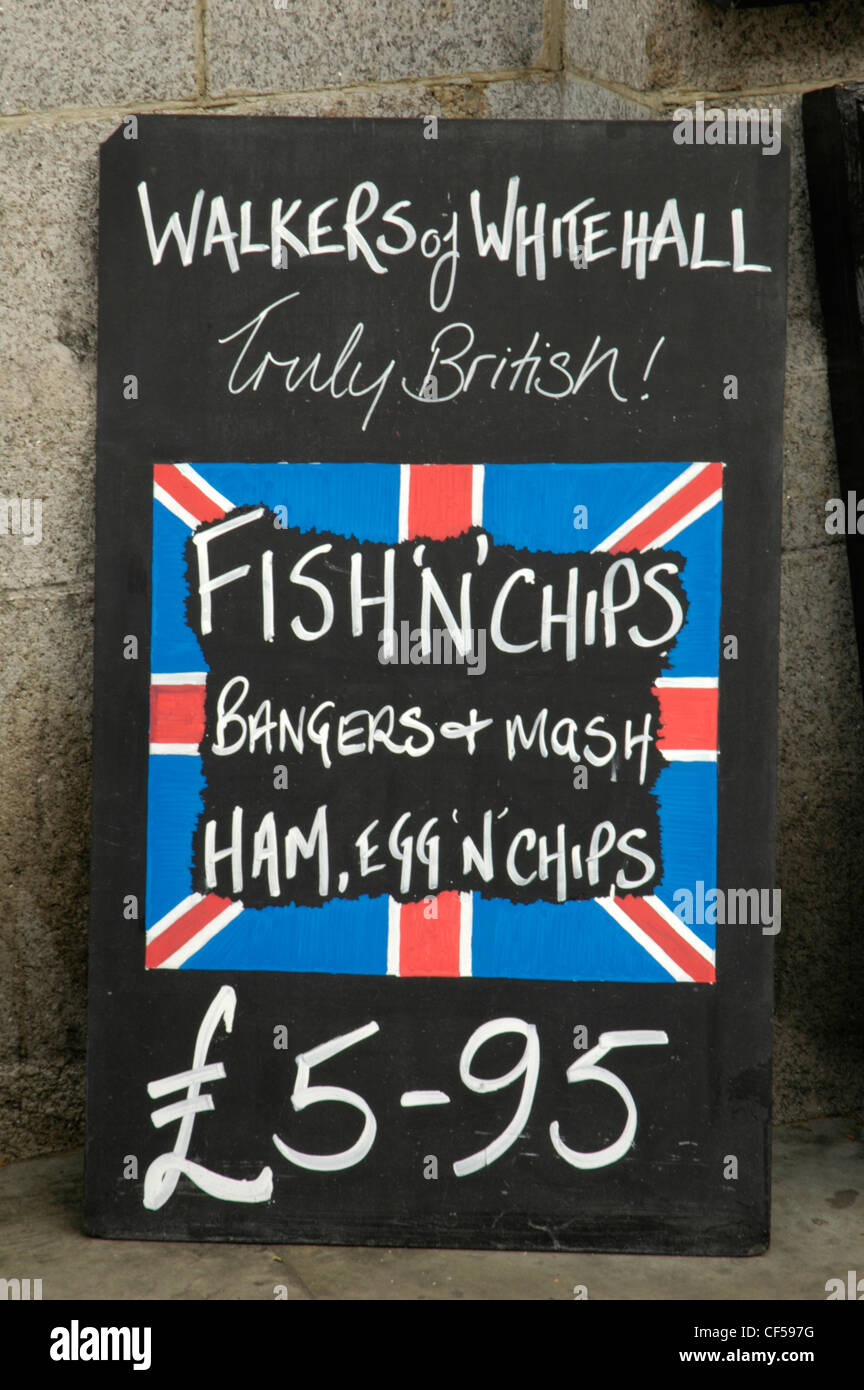 A hand written blackboard sign advertising traditional British food in ...