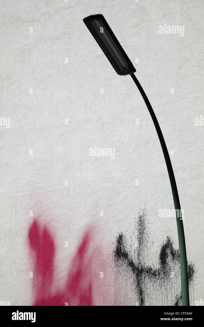 Germany, Berlin, Street light with graffiti wall in background Stock ...