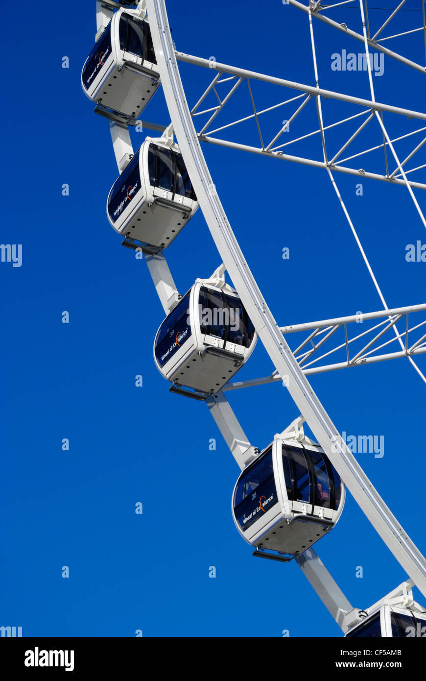 A close up observation of a ferris wheel against a deep blue sky in ...