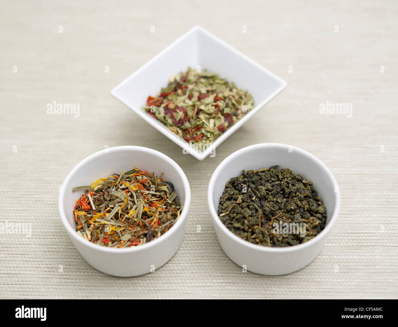 Varities of tea leaves in bowls on mat Stock Photo - Alamy