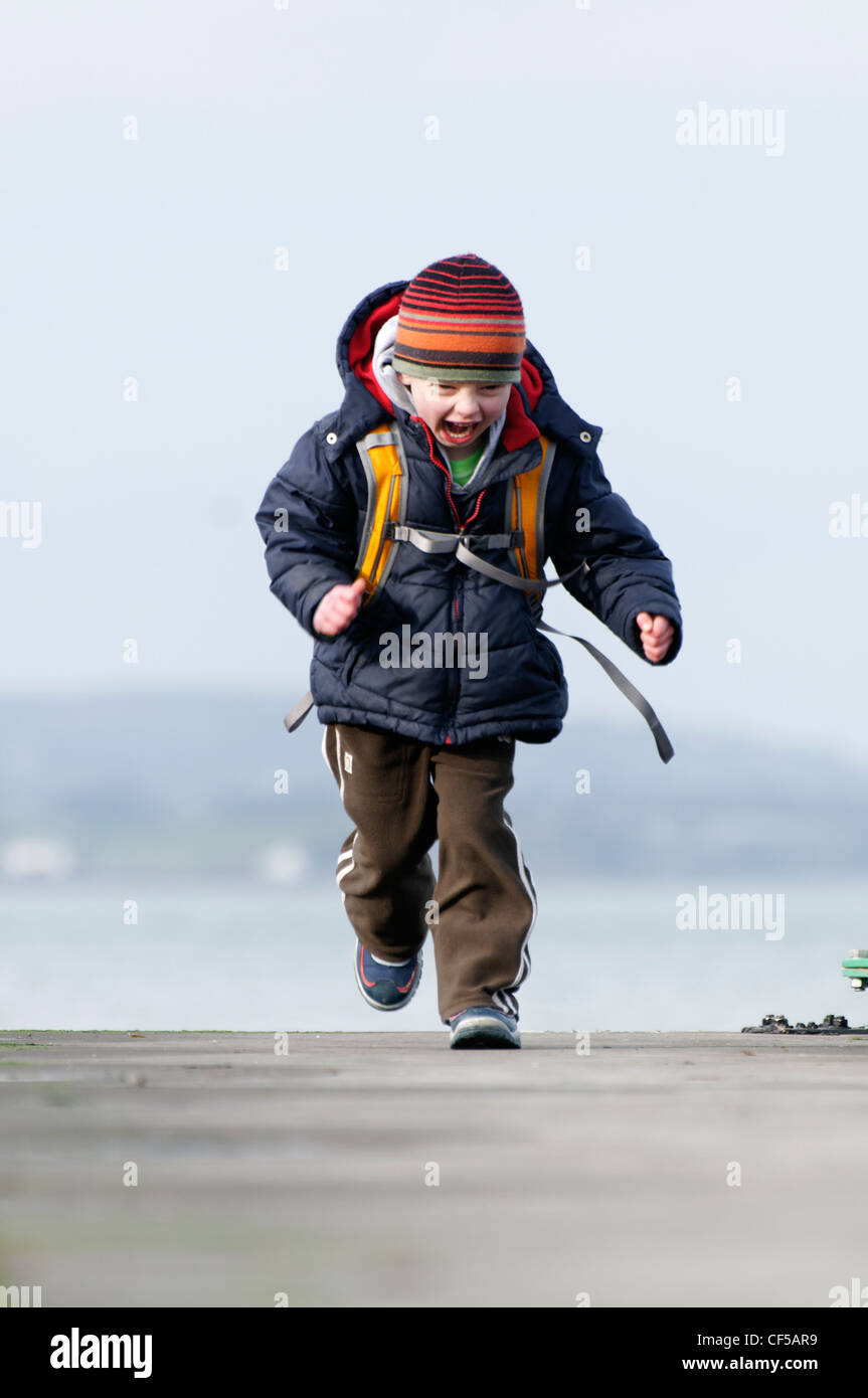 Boy running on jetty at the sea hi-res stock photography and images - Alamy
