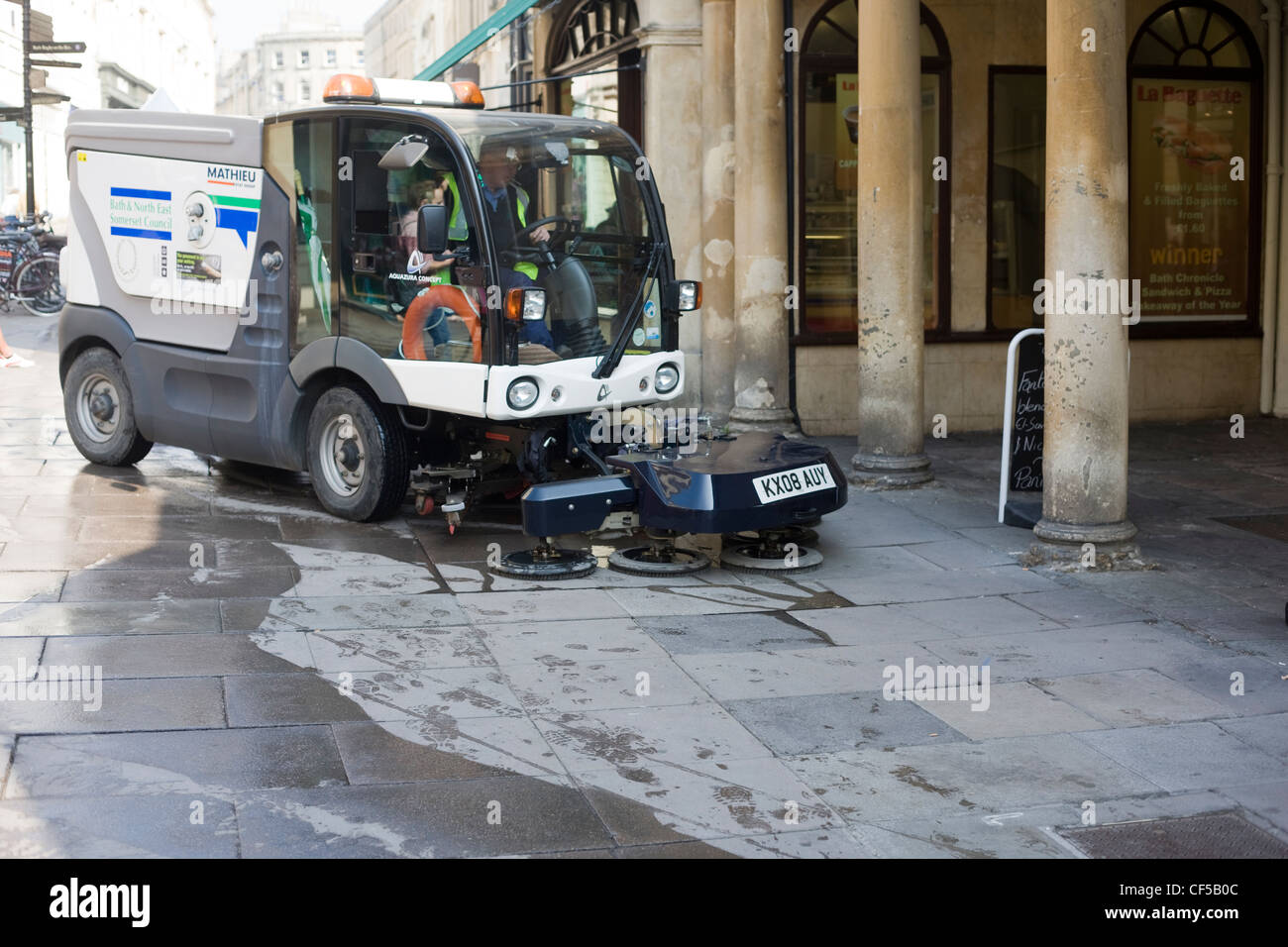 Street cleaning machine sweeping the pavement in Bath city centre ...