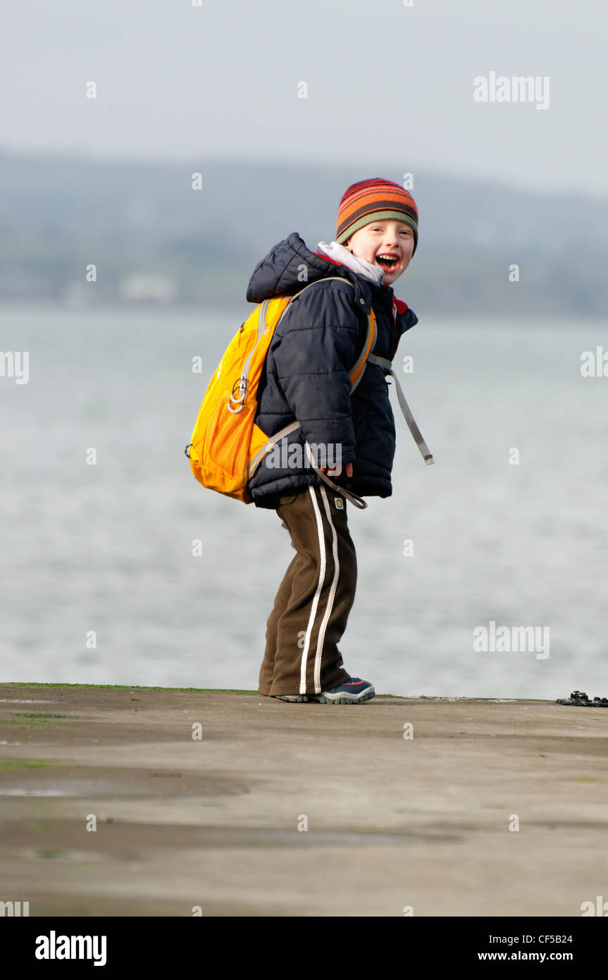 A boy running on a small jetty Stock Photo - Alamy