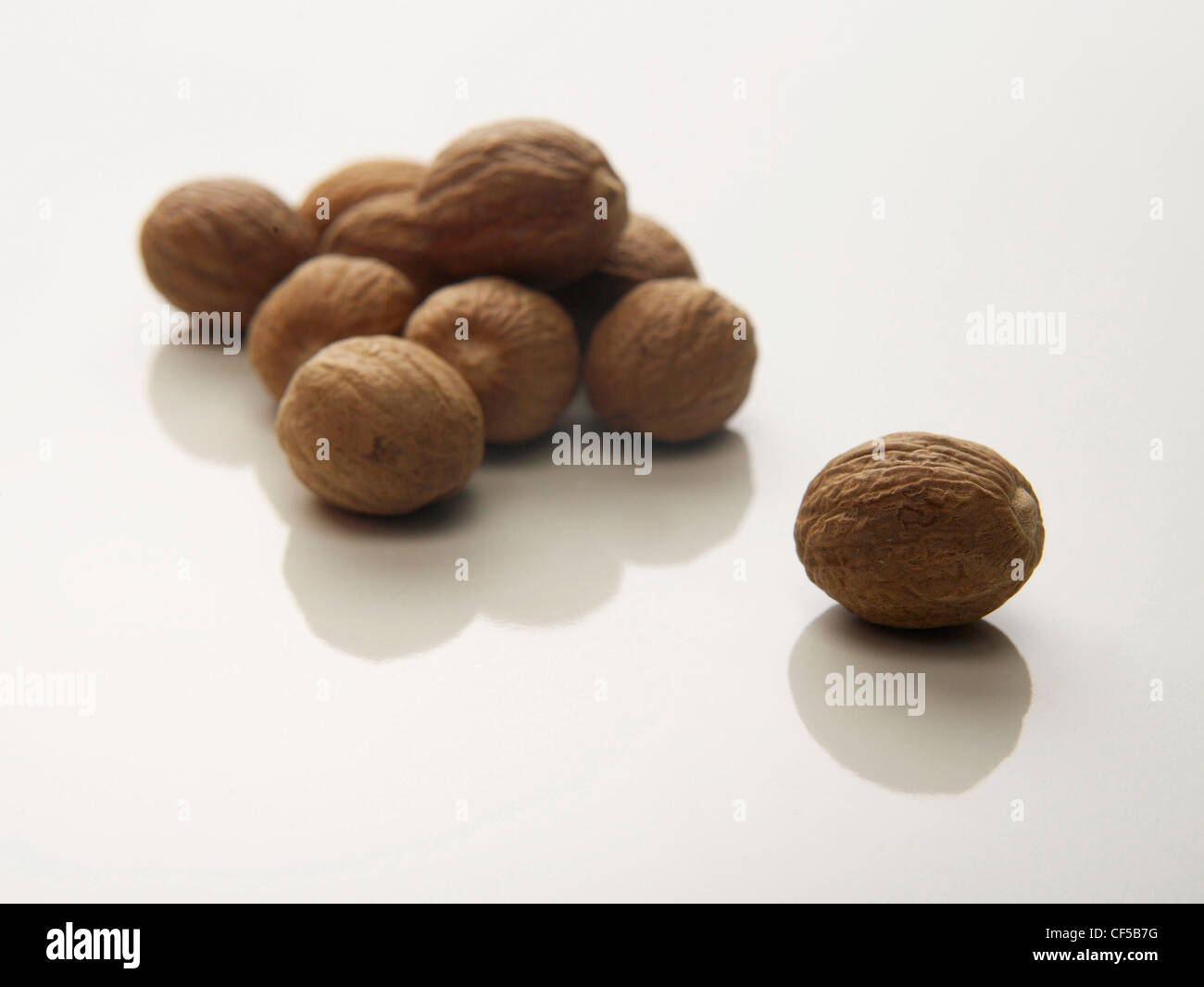 Nutmeg on white background, close up Stock Photo - Alamy