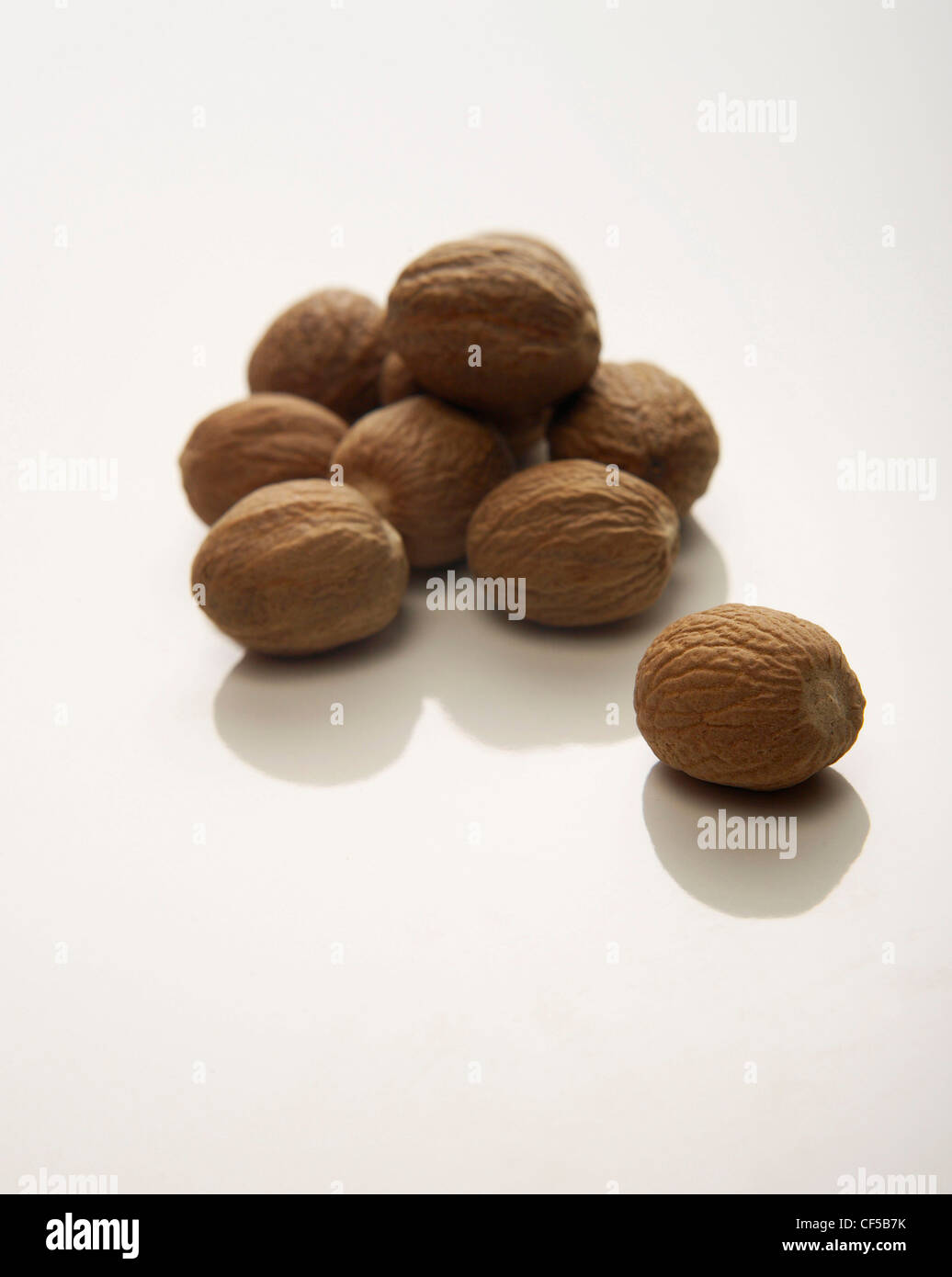 Nutmeg on white background, close up Stock Photo - Alamy