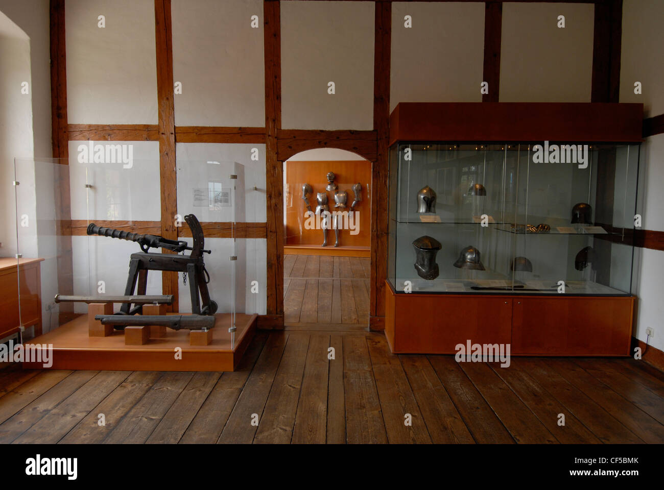 A museum display of a knight's armour suit ,filed gun and helmets in ...